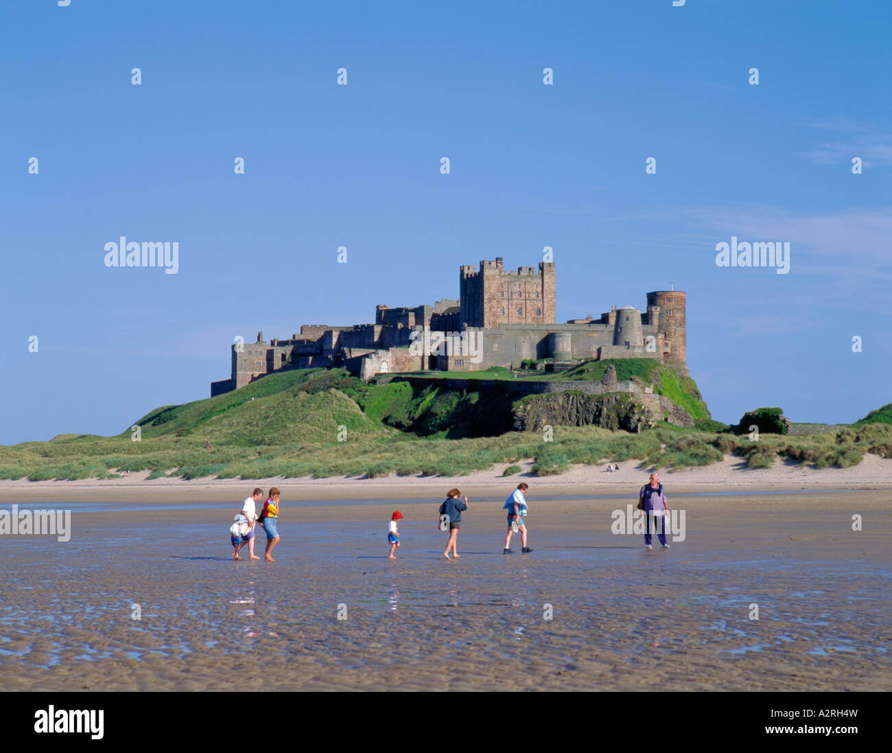 Bamburgh Castle seen over the beach, Bamburgh, Northumberland, England ...