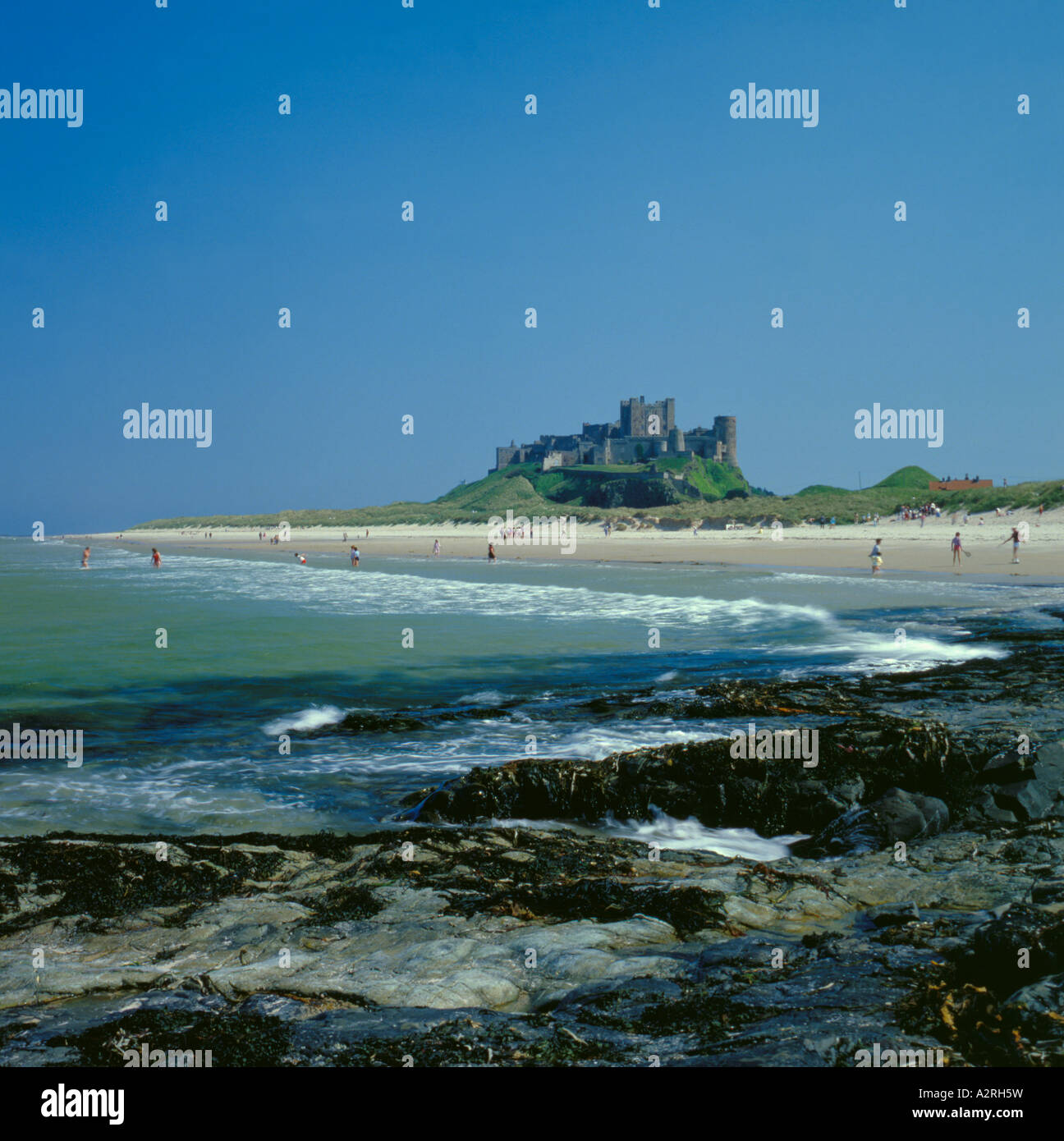 Bamburgh Castle seen over the beach, Bamburgh, Northumberland, England ...
