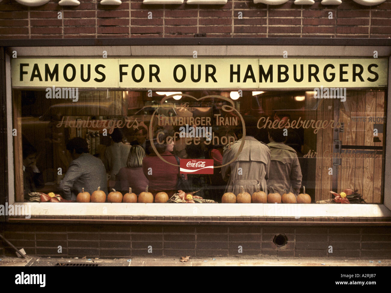 view through window of people queuing inside the hamburger train shop ...
