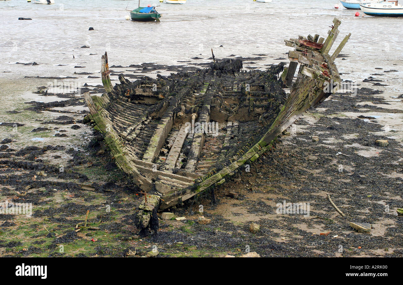 wreck of boat beached on riverbank Stock Photo - Alamy