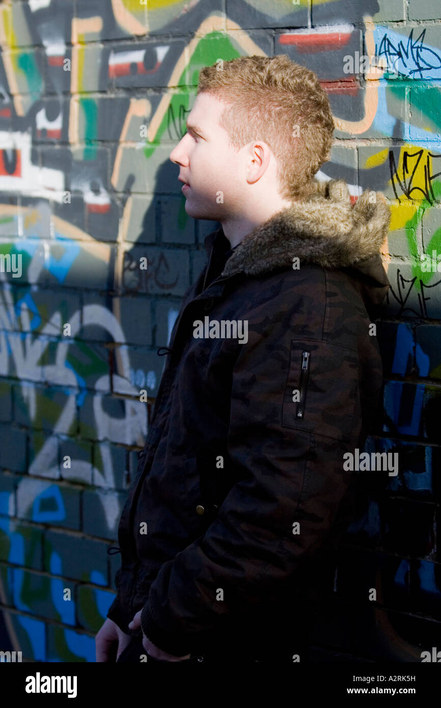young teenage boy teenager rebellious male youth graffiti brick wall ...