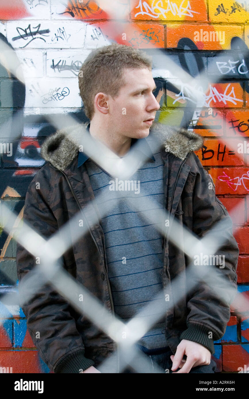 young teenage boy teenager rebellious male youth graffiti brick wall ...