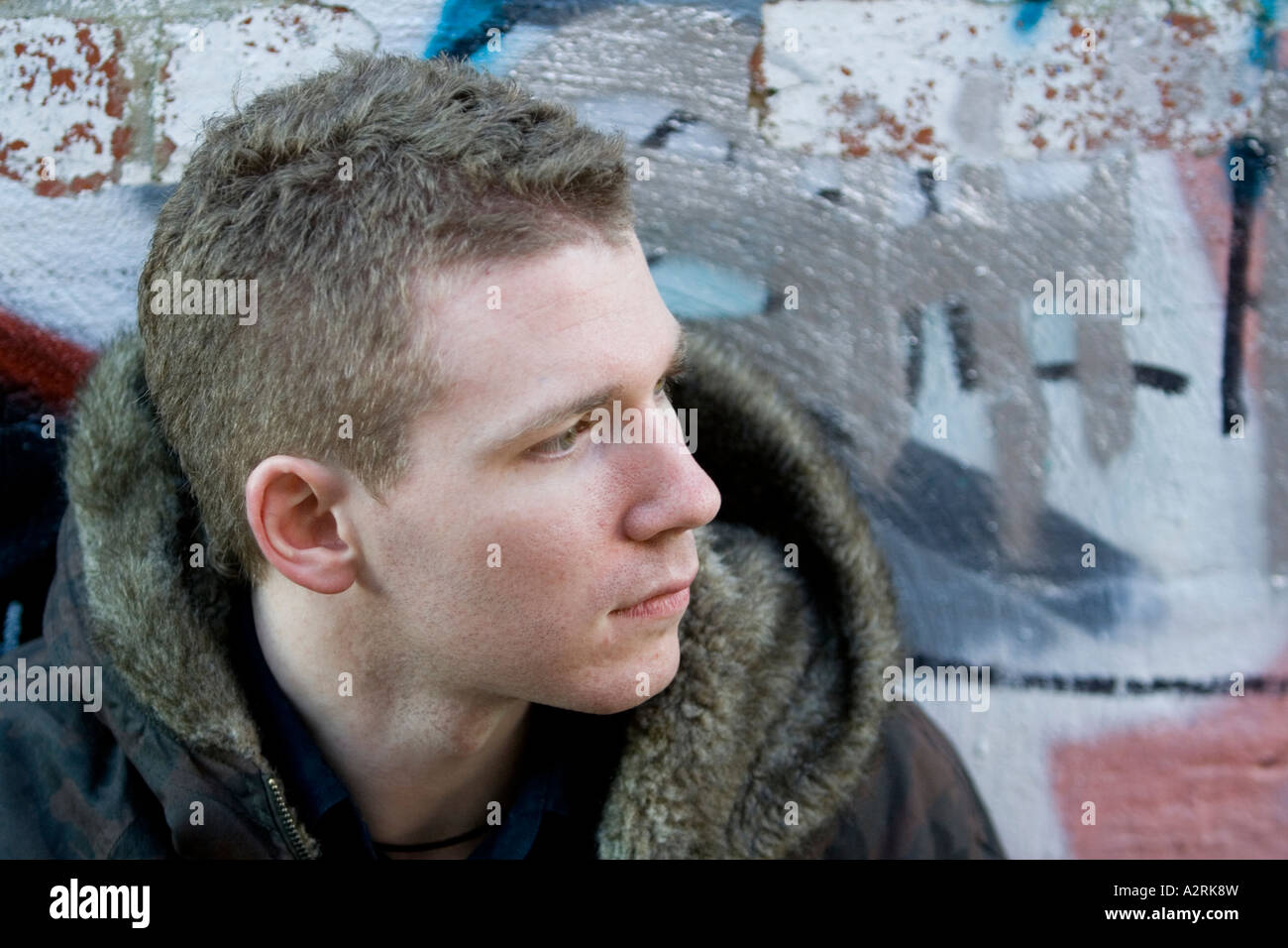 young teenage boy teenager rebellious male youth graffiti brick wall ...