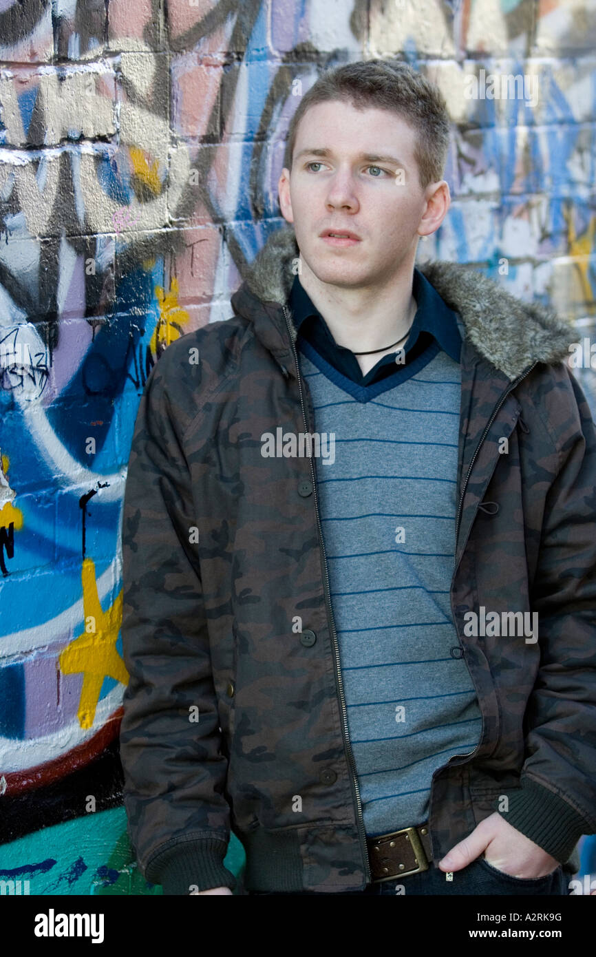 young teenage boy teenager rebellious male youth graffiti brick wall ...