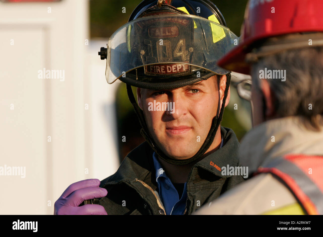A fire fighter receiving orders from the Deputy Chief while holding the ...