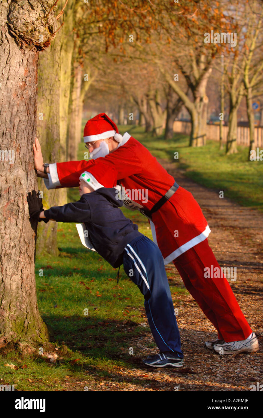 A FATHER AND SON IN FATHER CHRISTMAS FANCY DRESS OUTFITS STRETCH OFF ...