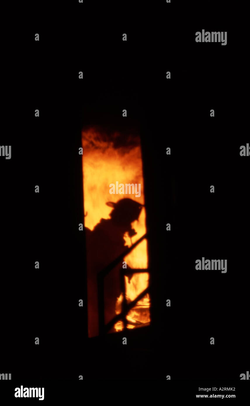 Fire fighter with gear in a room of fire Stock Photo - Alamy