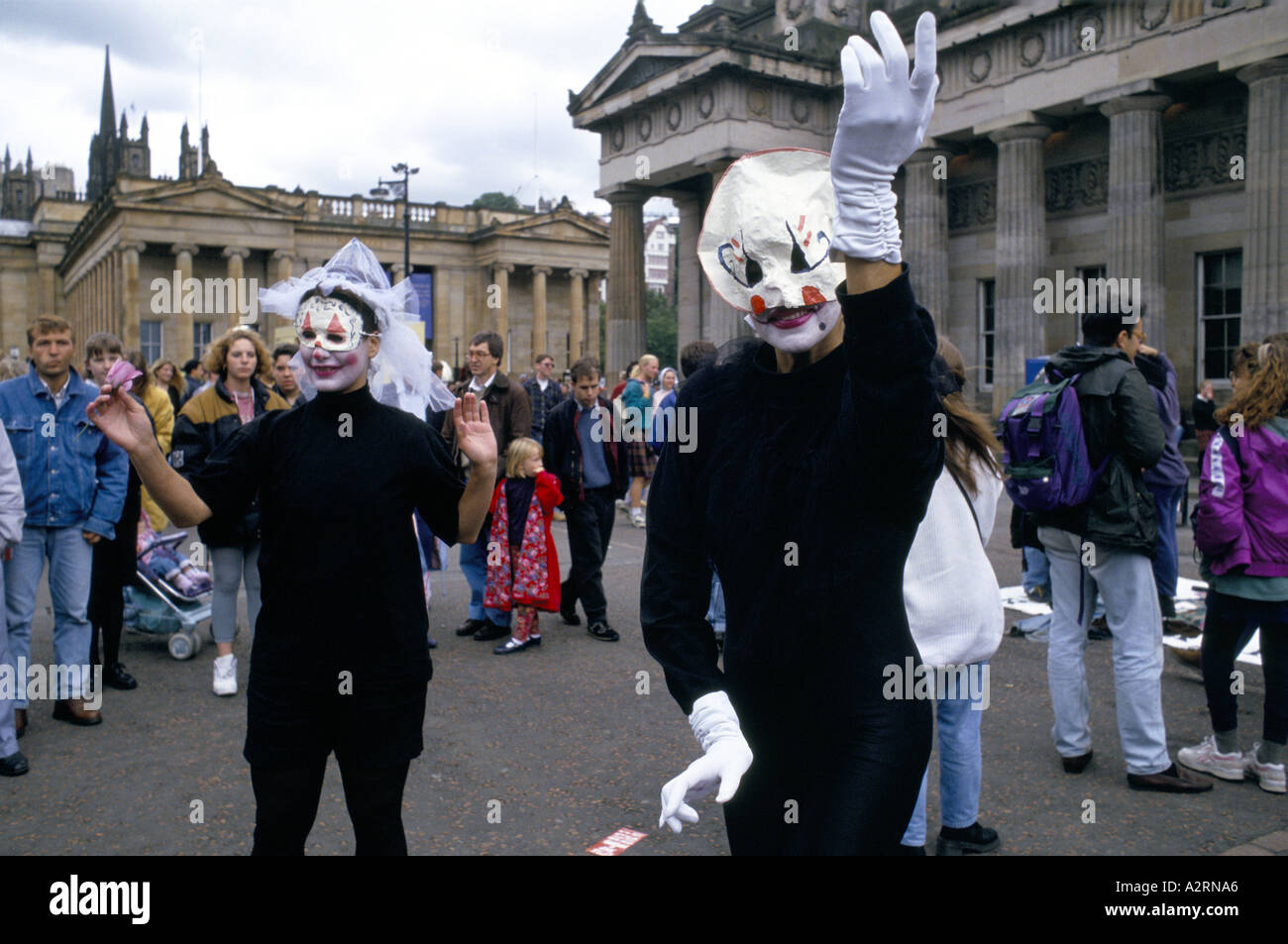 street mime performers with face paint eye masks performing on street ...