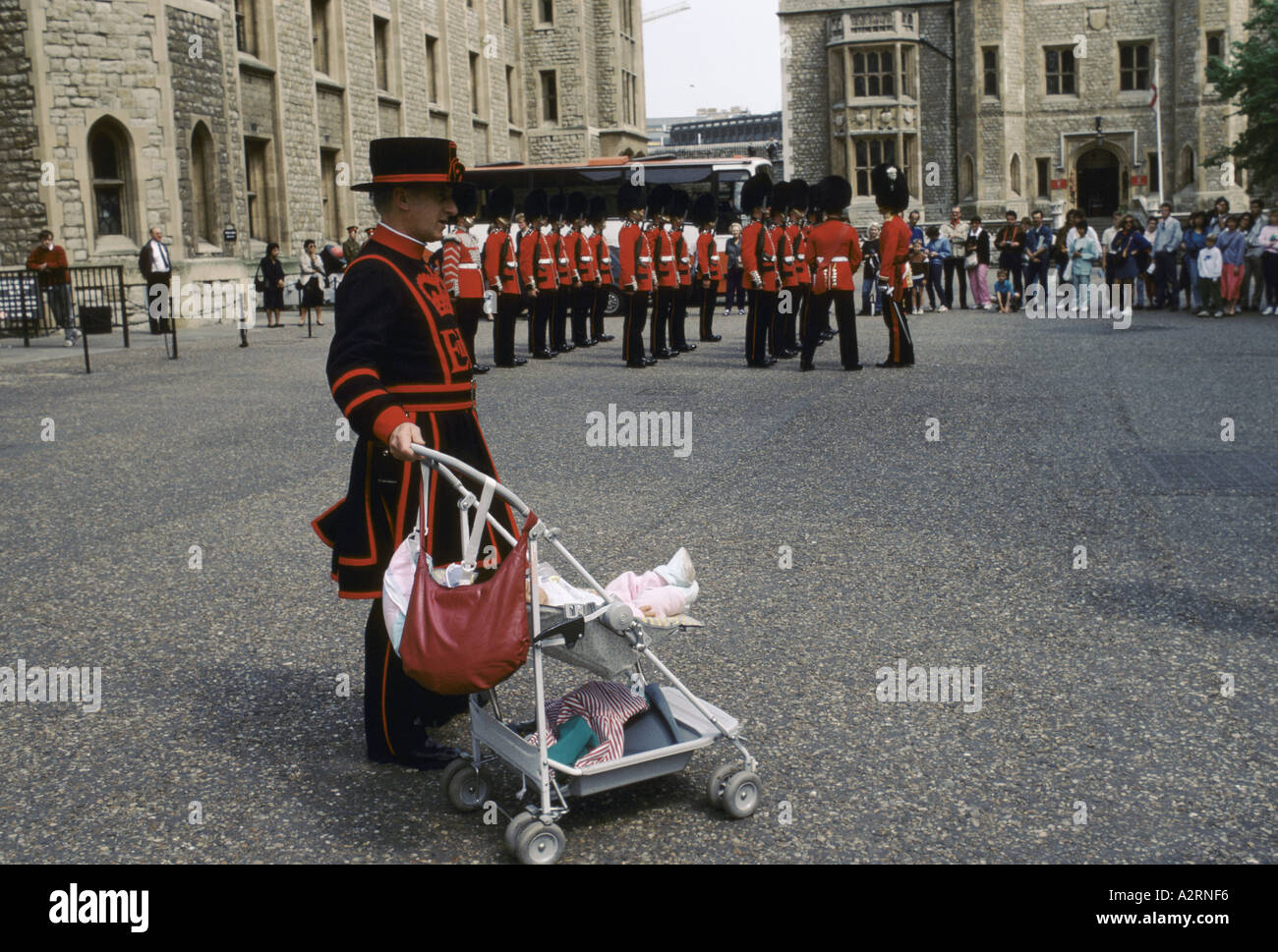 beefeater holding pram with baby tower of london Stock Photo - Alamy