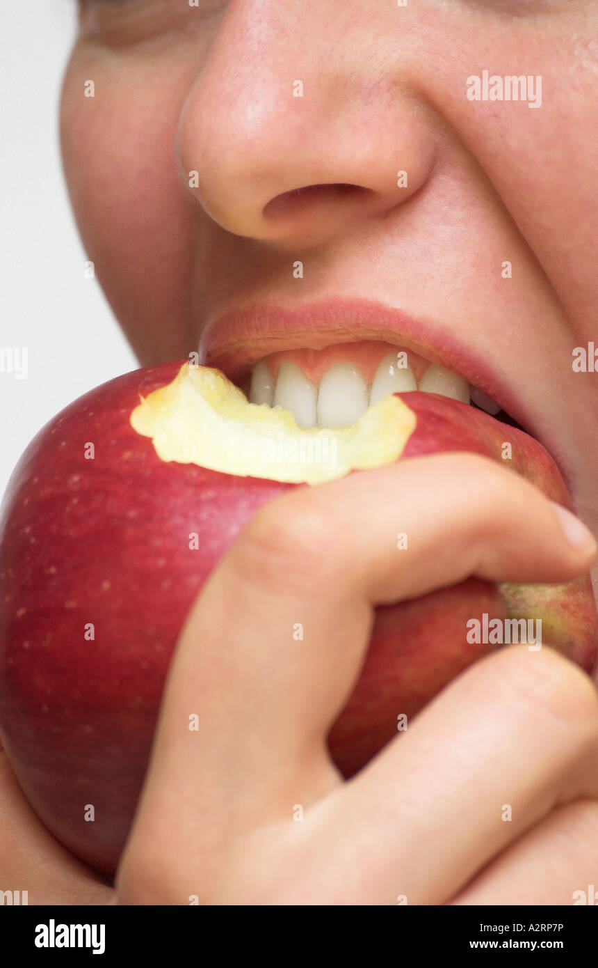 Young woman eating apple close up Stock Photo - Alamy