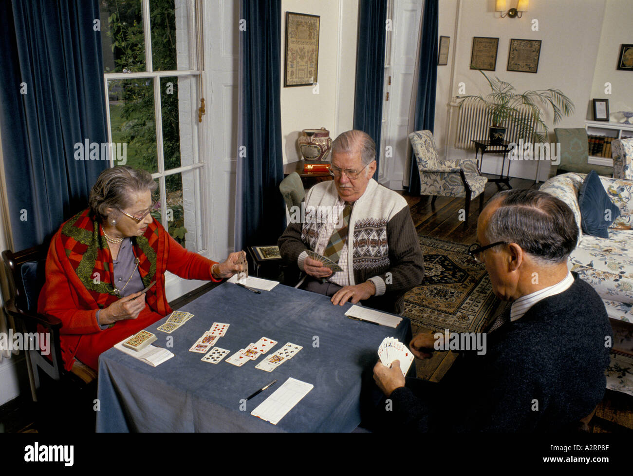 Playing Bridge. Seniors elderly old age pensioners playing a card game ...