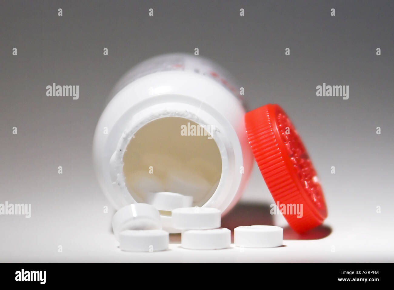 White Pills, Bottle and Red Lid Stock Photo - Alamy