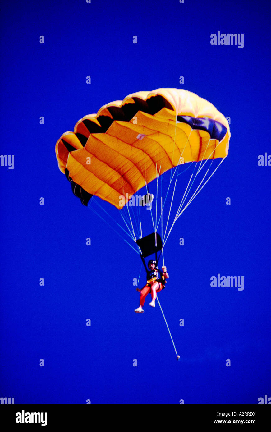 One Sky Diver skydiving with a Yellow Parachute Stock Photo - Alamy