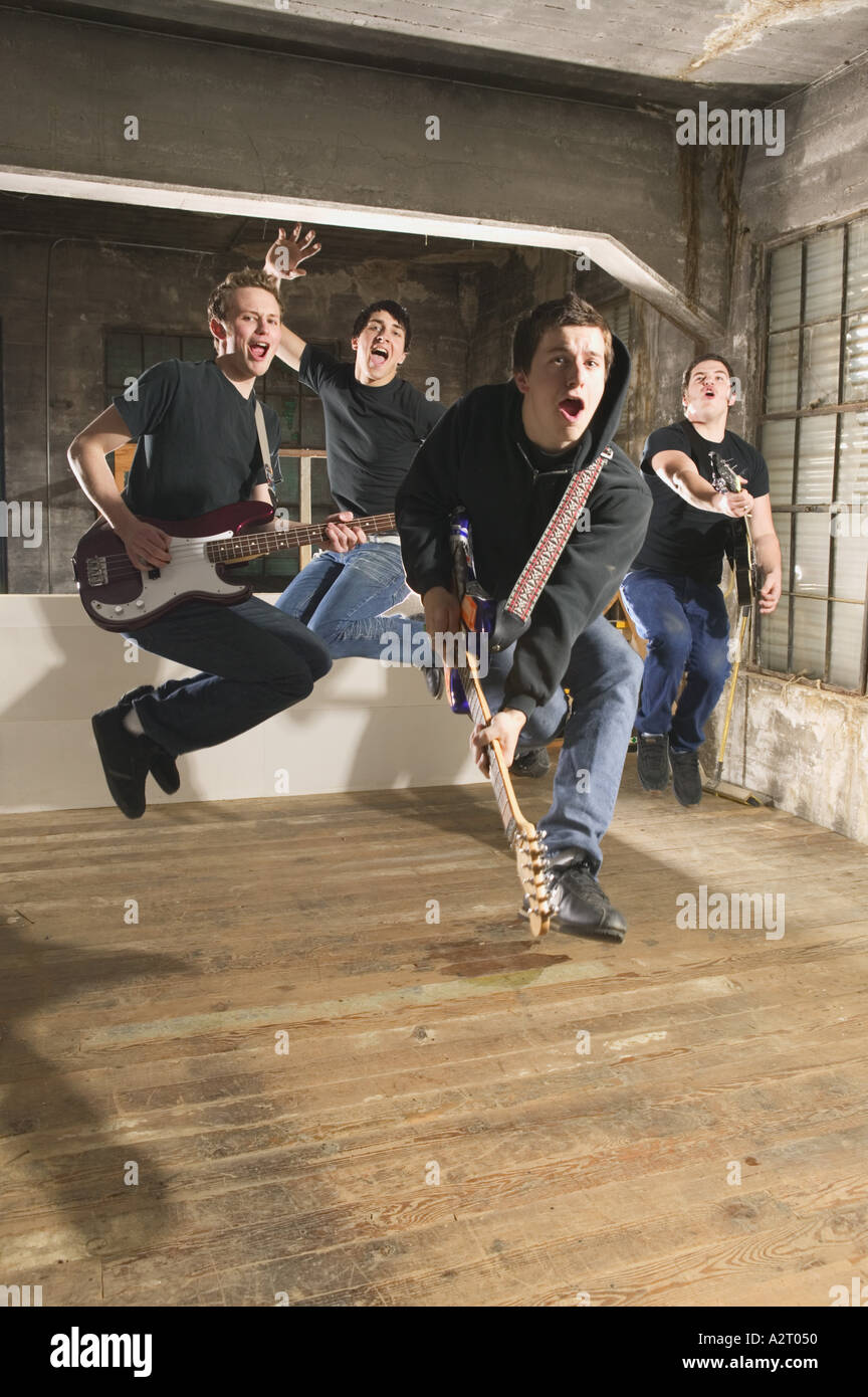 Four men in a band rock out Stock Photo - Alamy