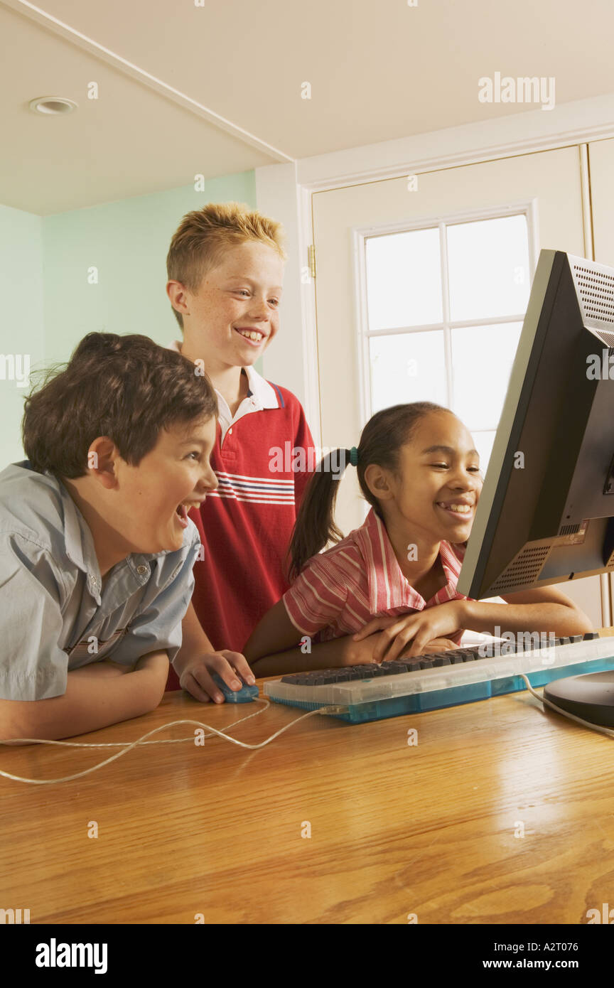 Three children sharing a home computer Stock Photo - Alamy