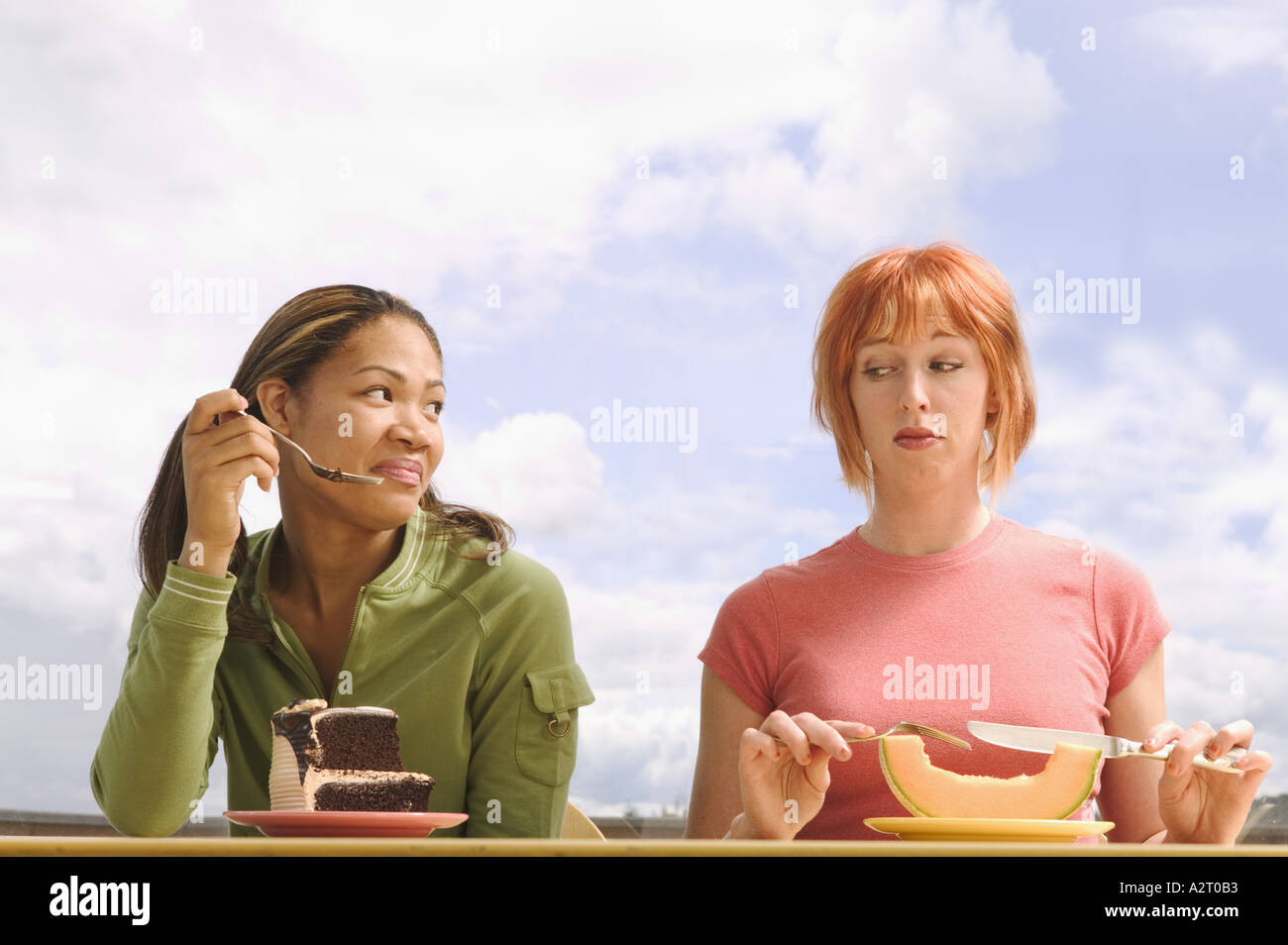 Two women eat different food hi-res stock photography and images - Alamy