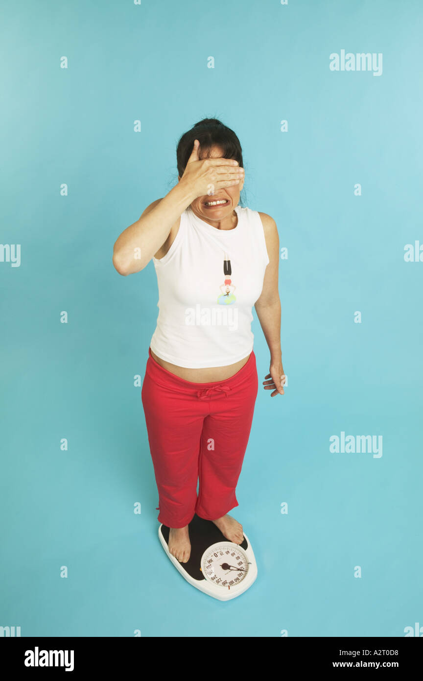 Woman on scale in hi-res stock photography and images - Alamy