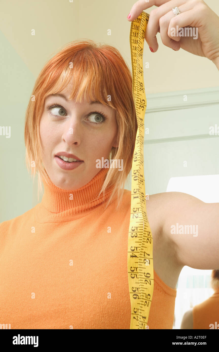 Measuring tape and young woman Stock Photo - Alamy