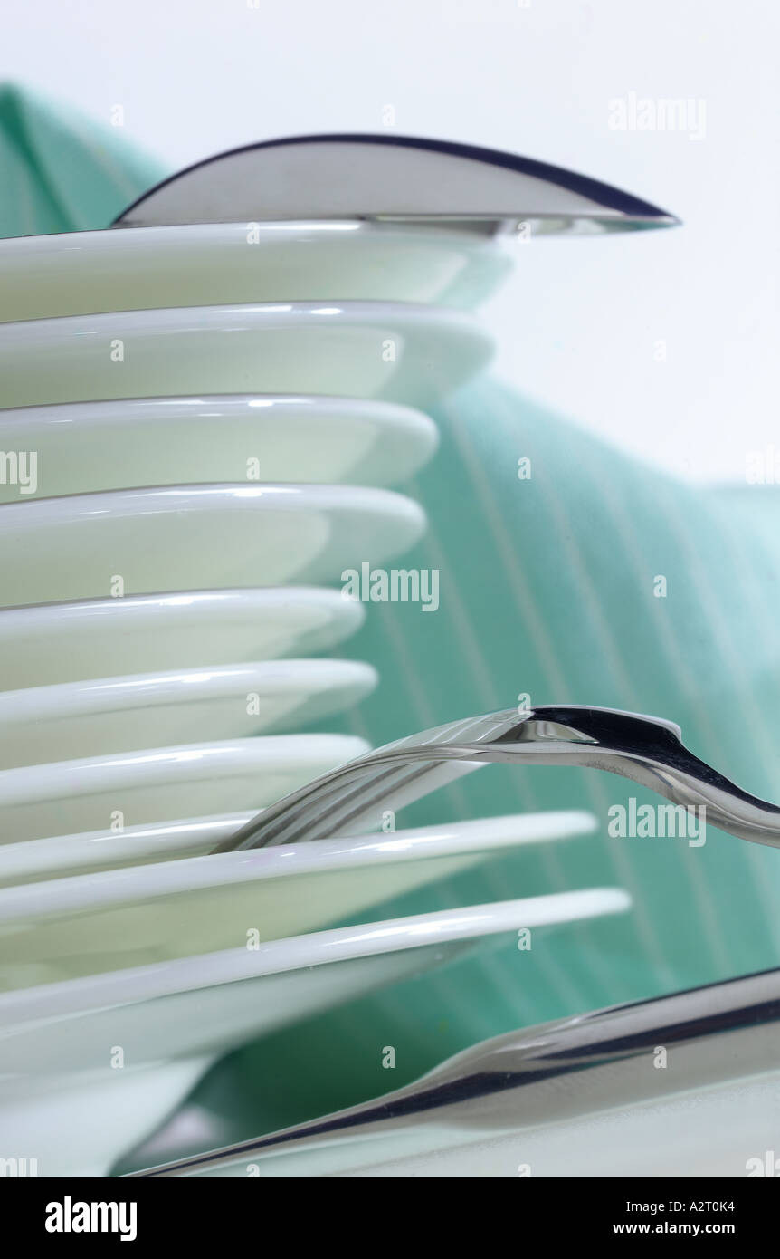 stack of plates with silverware Stock Photo - Alamy