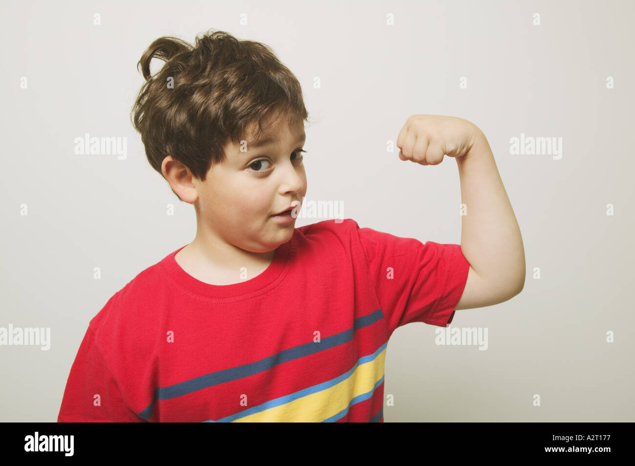 A young boy flexing his muscles Stock Photo - Alamy