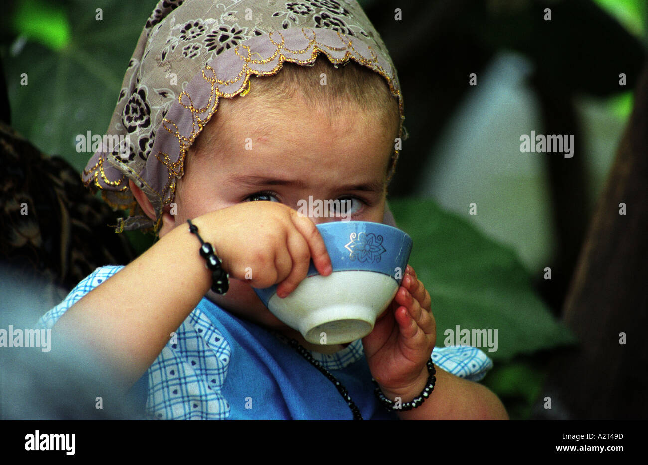 Little girl drinking tea Stock Photo - Alamy