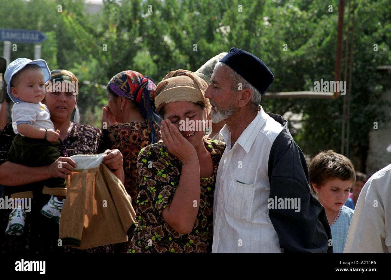 The boy s mother can hardly restrain her feelings Her father tries to ...