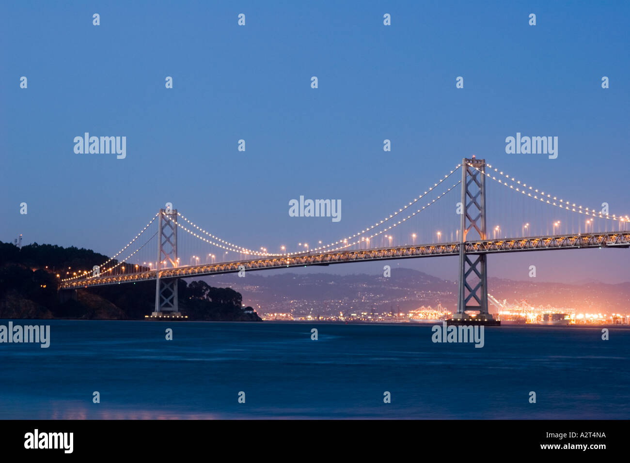 San Francisco-Oakland Bay Bridge at night with the Port of Oakland ...
