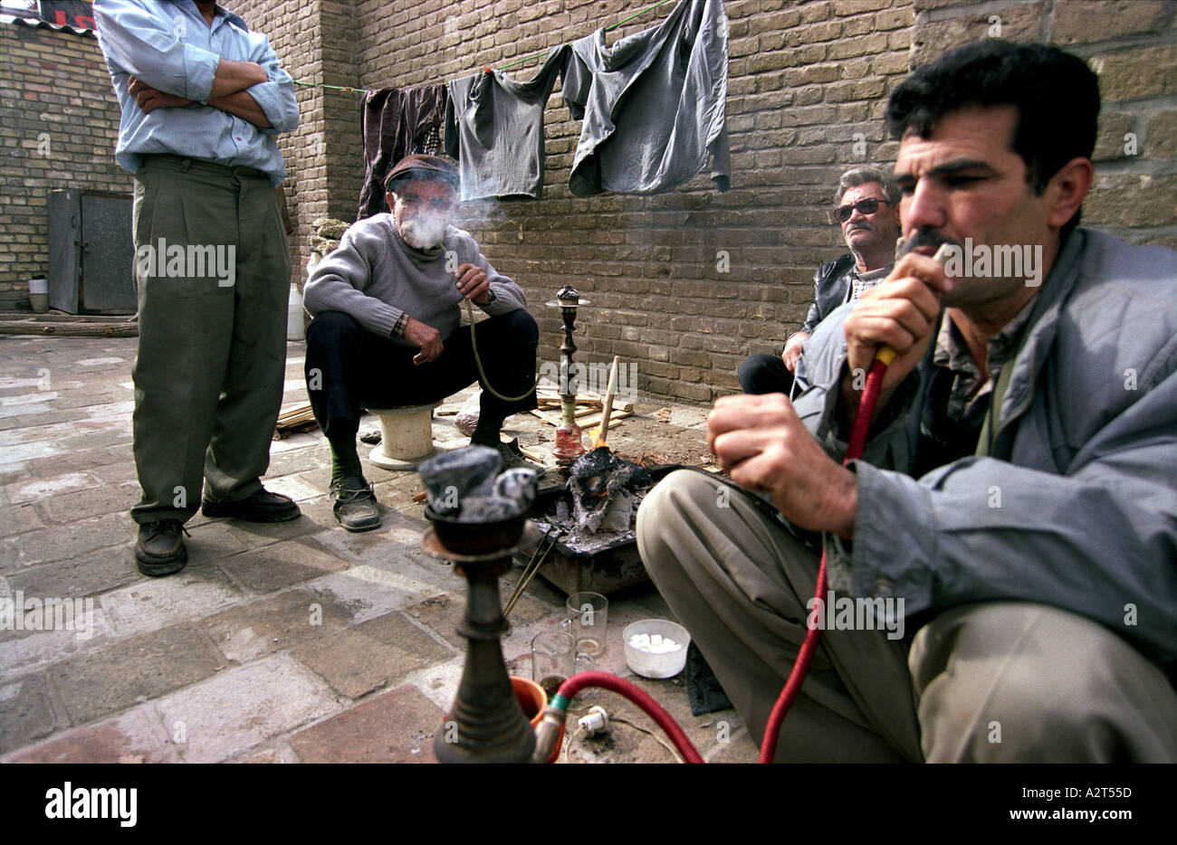 People in the church yard smoking ghailan Stock Photo - Alamy