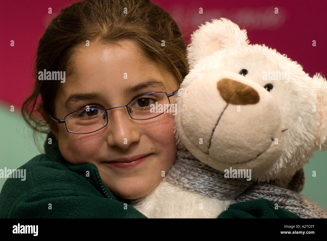 Ten year old school girl cuddling her teddy bear, Orpington, Kent UK ...