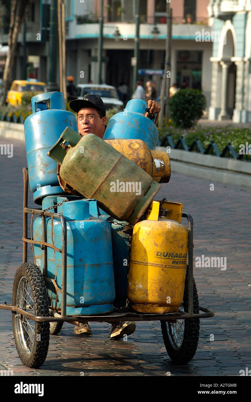 man riding pushing a cart full with domestic gas tanks Stock Photo - Alamy