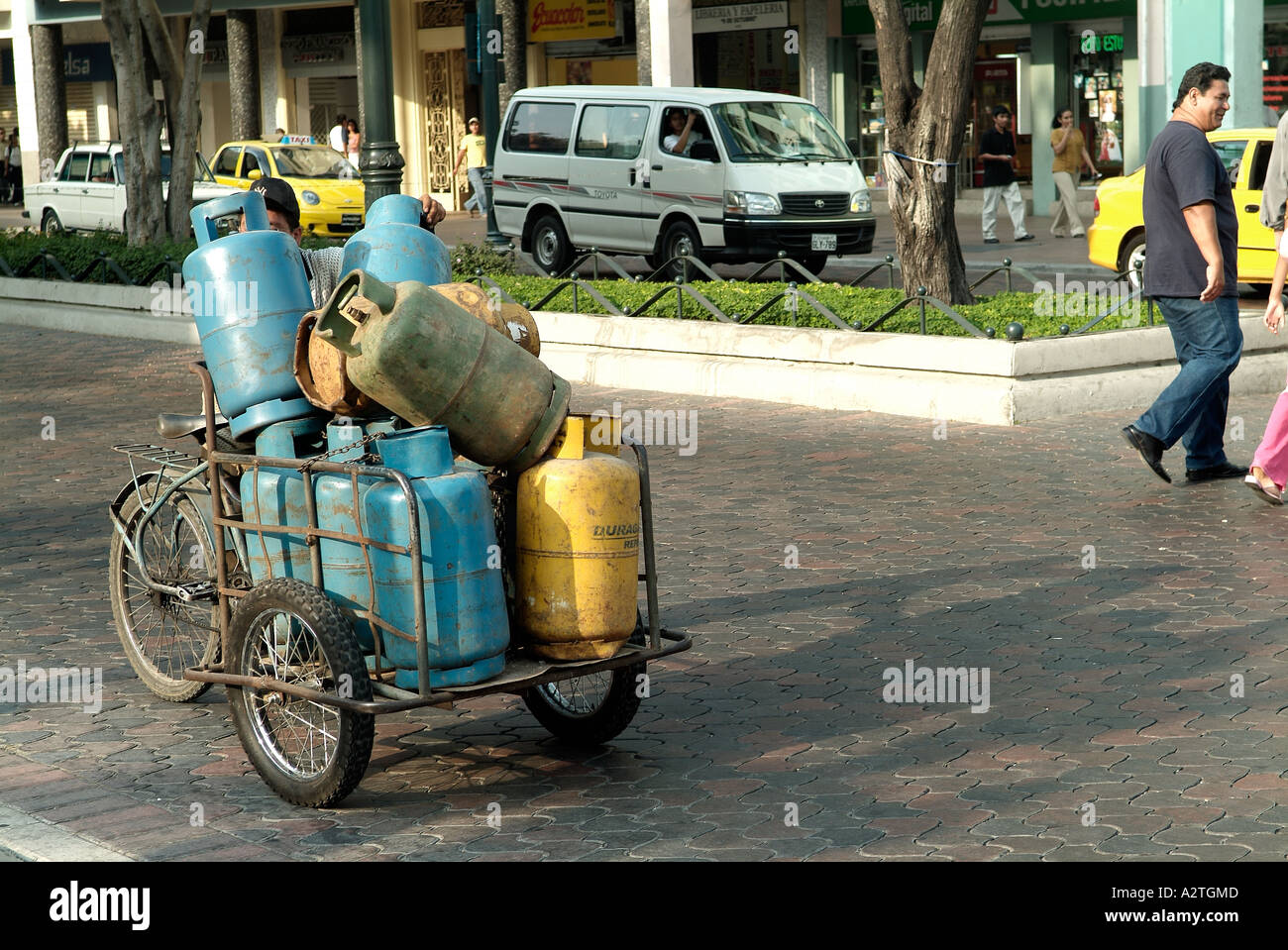 man riding pushing a cart full with domestic gas tanks Stock Photo - Alamy