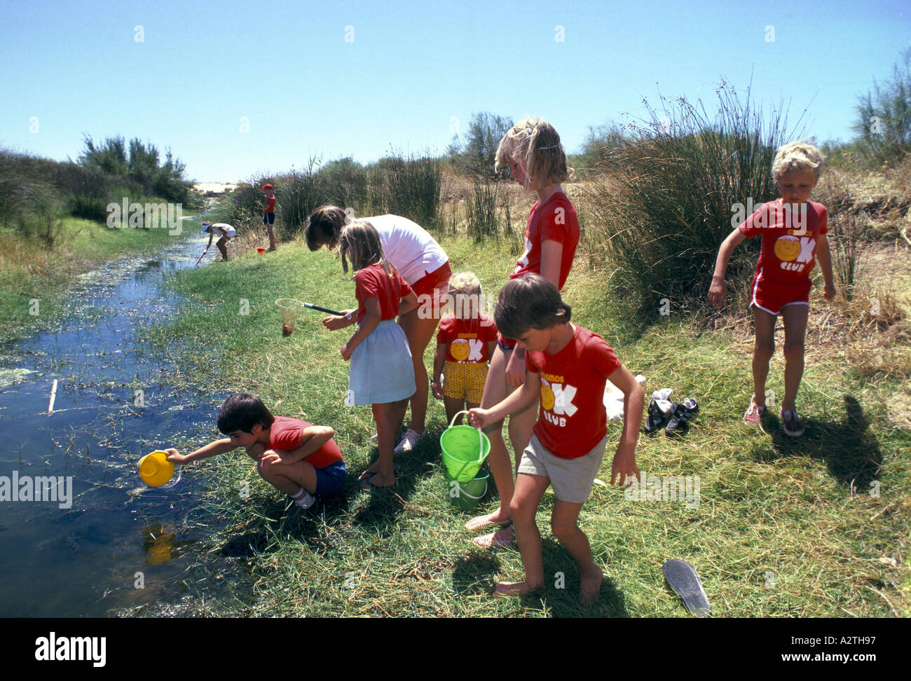 children playing fishing by water Stock Photo - Alamy