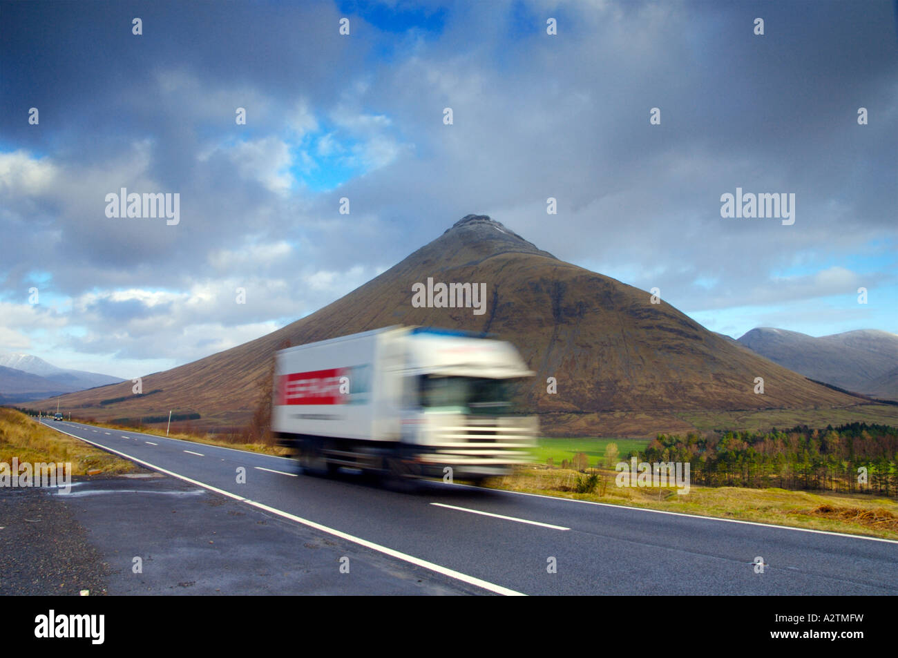 Transportation lorry moving along scottish highland road at speed Stock ...
