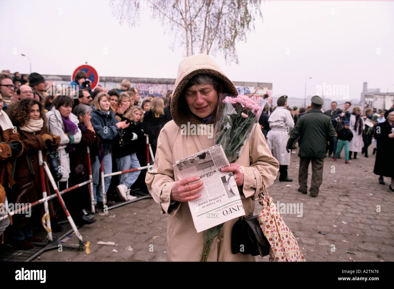 woman crying with joy as the berlin wall is opened to eastern germans ...