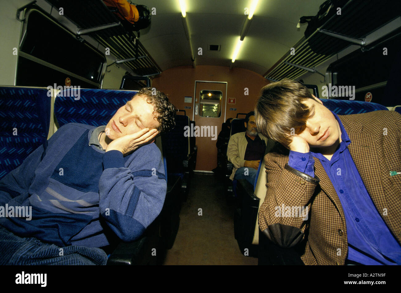 two men asleep on a train Stock Photo - Alamy