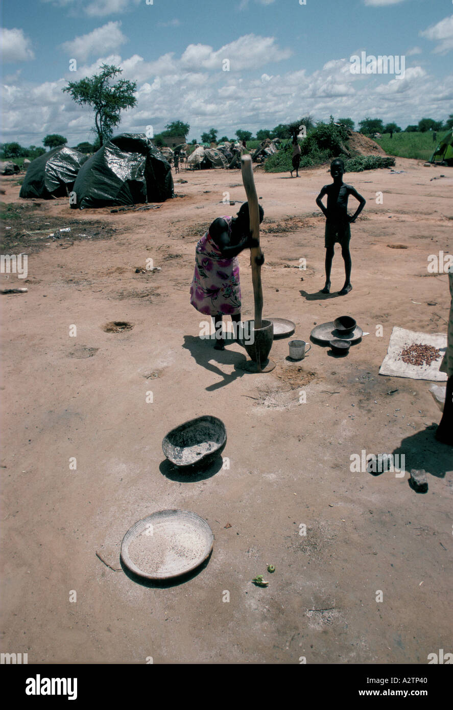 woman pounding with pestle and morter el muglad famine camp sudan 1988 ...