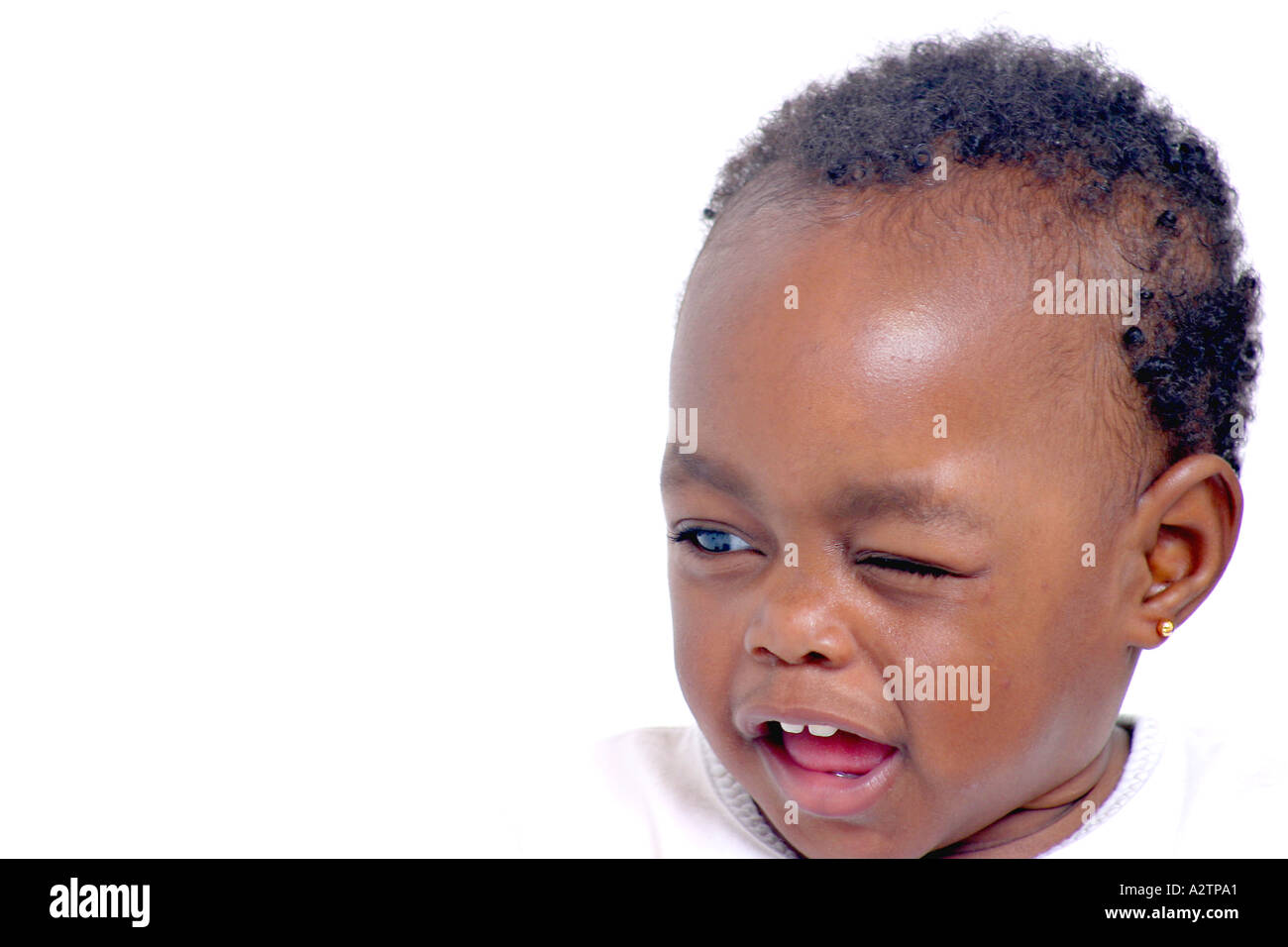 Black baby girl looking sideways and winking with her left eye Stock ...