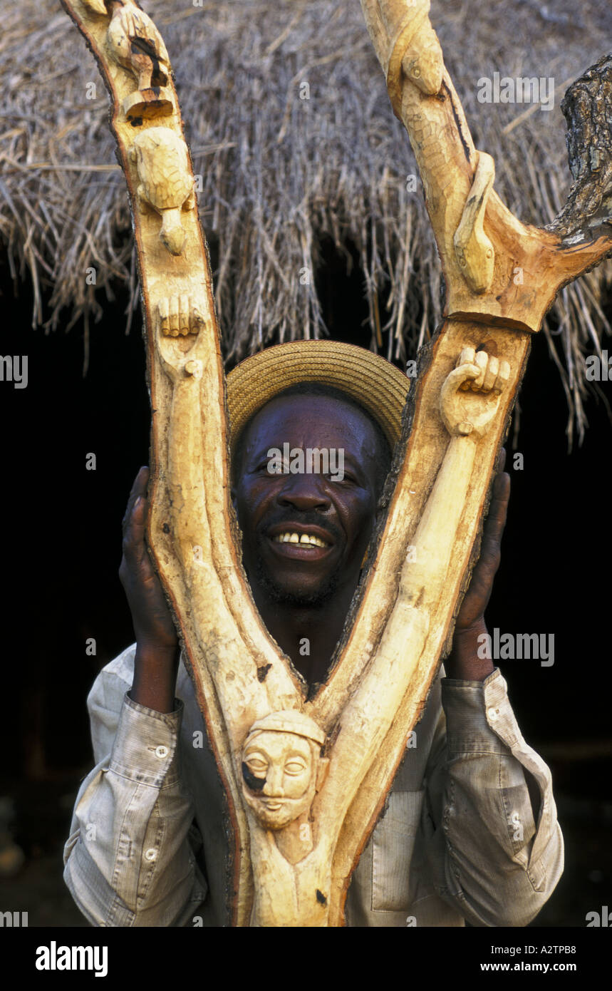 Niassa Mozambique . Man with a crucifix he has carved out of a branch ...