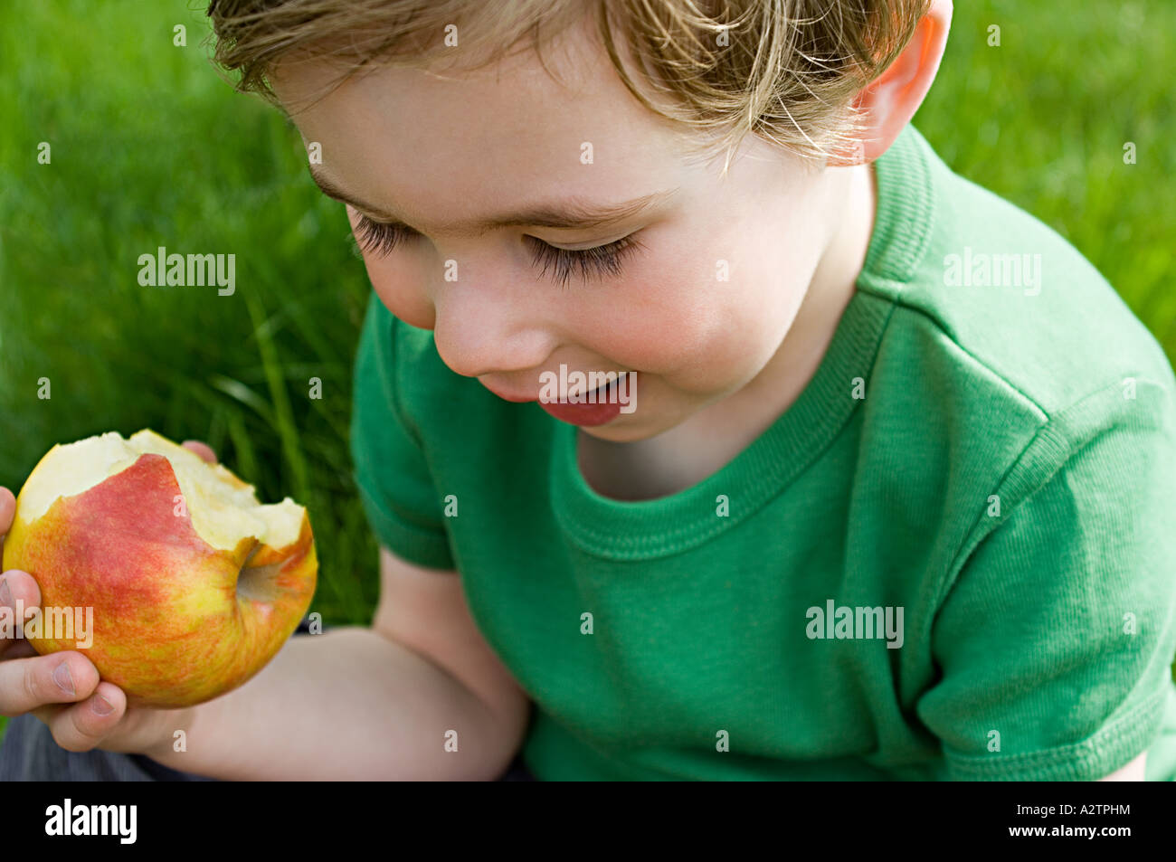 Boy eating apple Stock Photo - Alamy