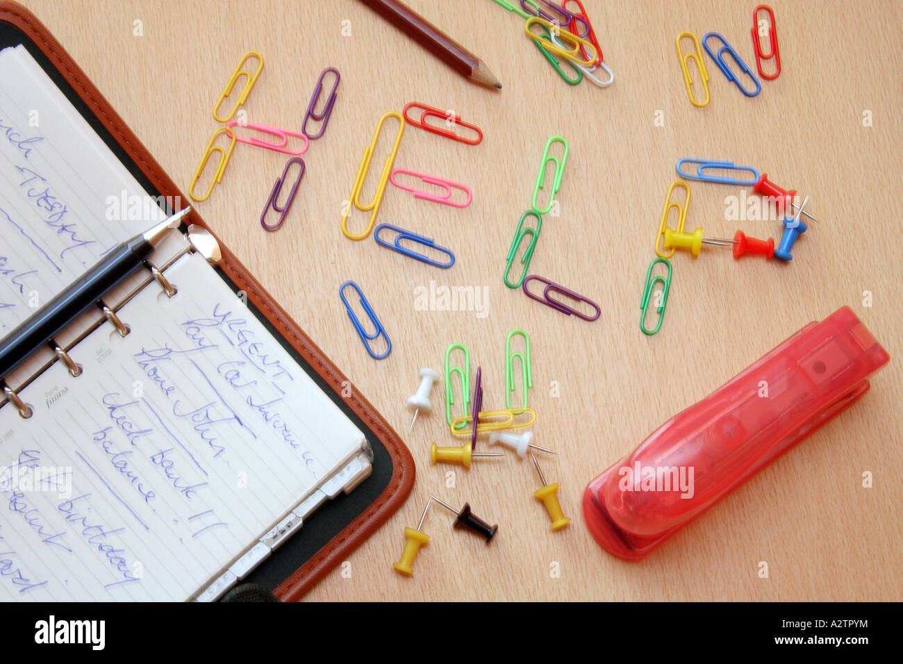 Diary paper clips pencil help Stock Photo - Alamy