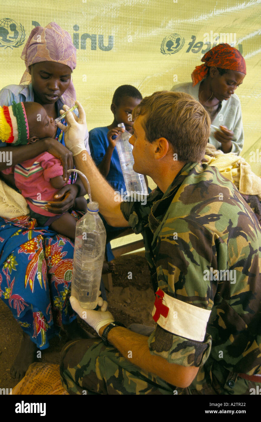 British army medic in Rwanda, camp for displaced,caring for local child ...