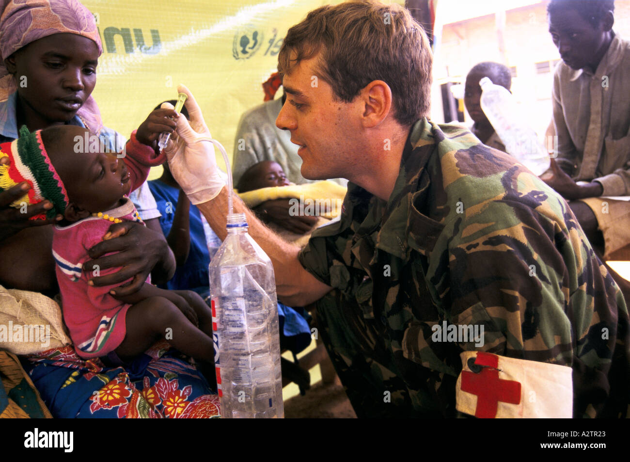 British army medic in Rwanda, camp for displaced,caring for local child ...