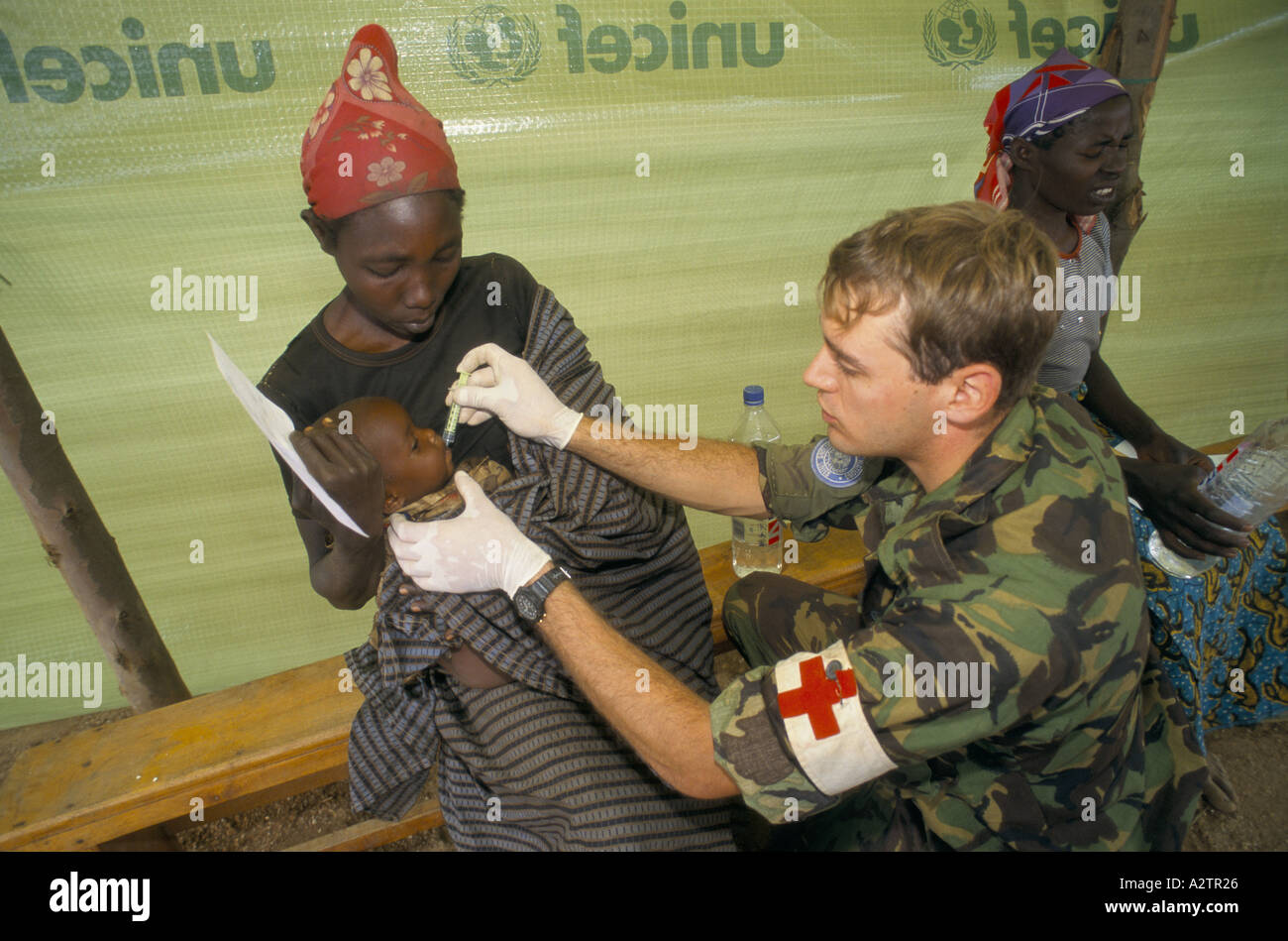 British army medic in Rwanda, camp for displaced,caring for local child ...