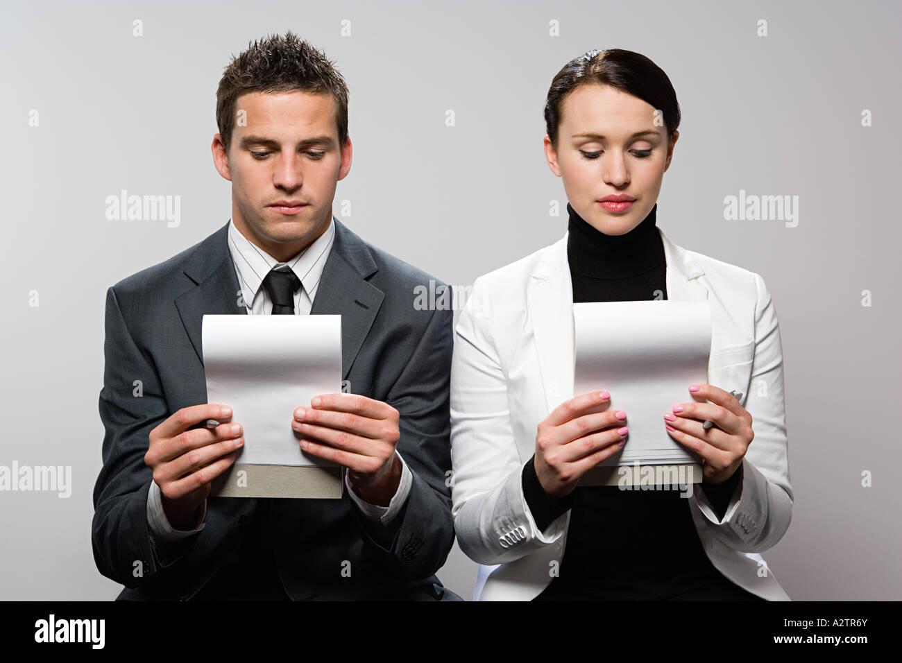 Two colleagues looking at notebook Stock Photo - Alamy