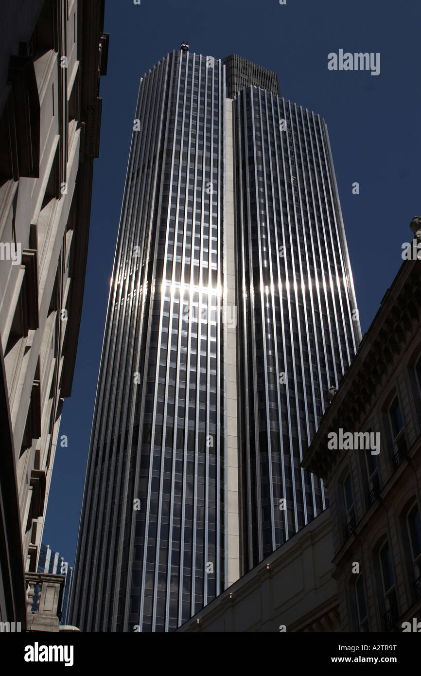 Tower 42 tall skyscraper commercial office building against blue sky ...