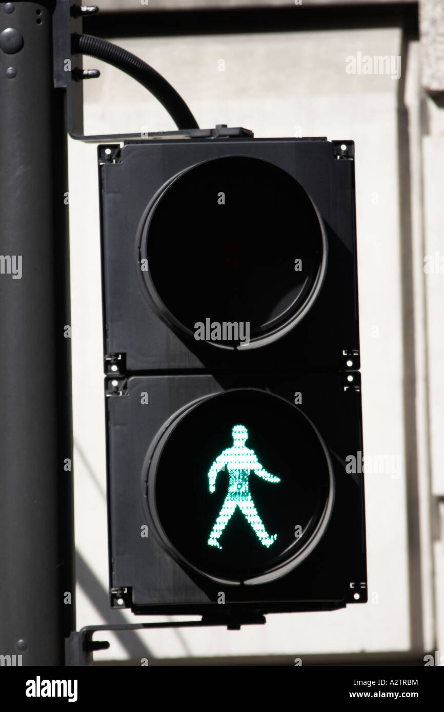 Pelican crossing pedestrian light with green man walking City of London ...