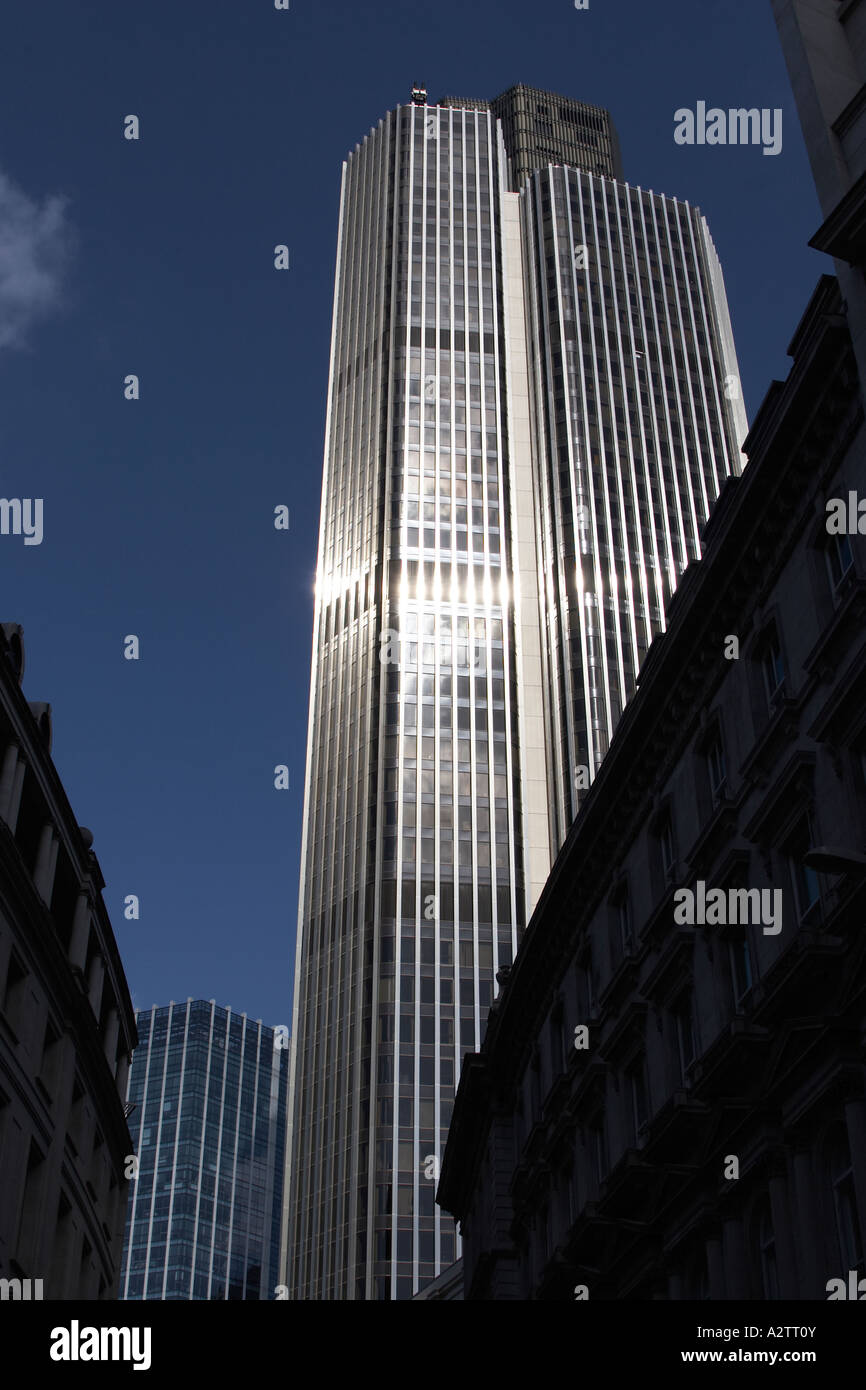 Tower 42 tall skyscraper commercial office building against blue sky ...