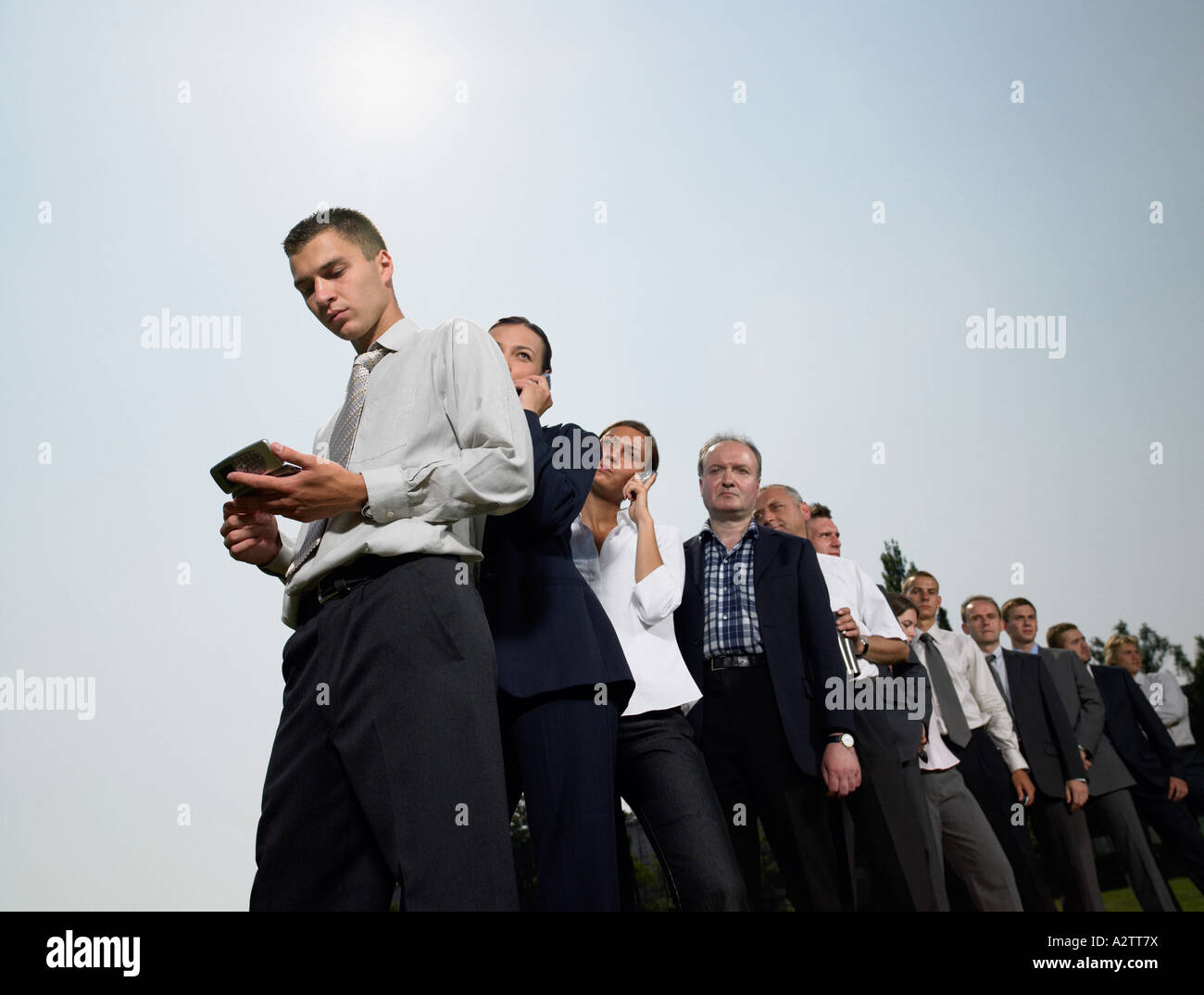 Businesspeople waiting in a queue Stock Photo - Alamy