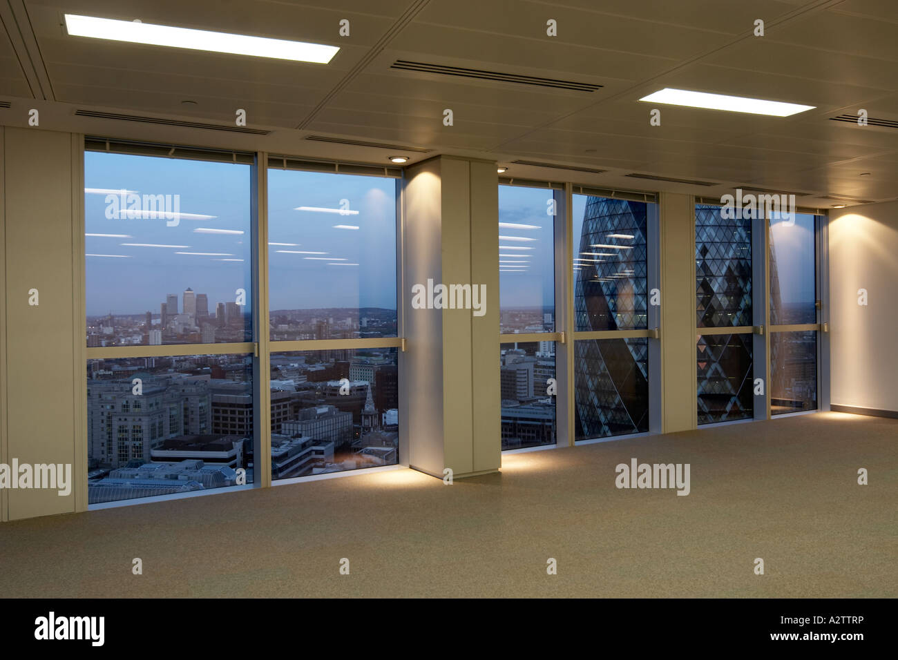 Empty floor of commercial office building at night with twilight view ...