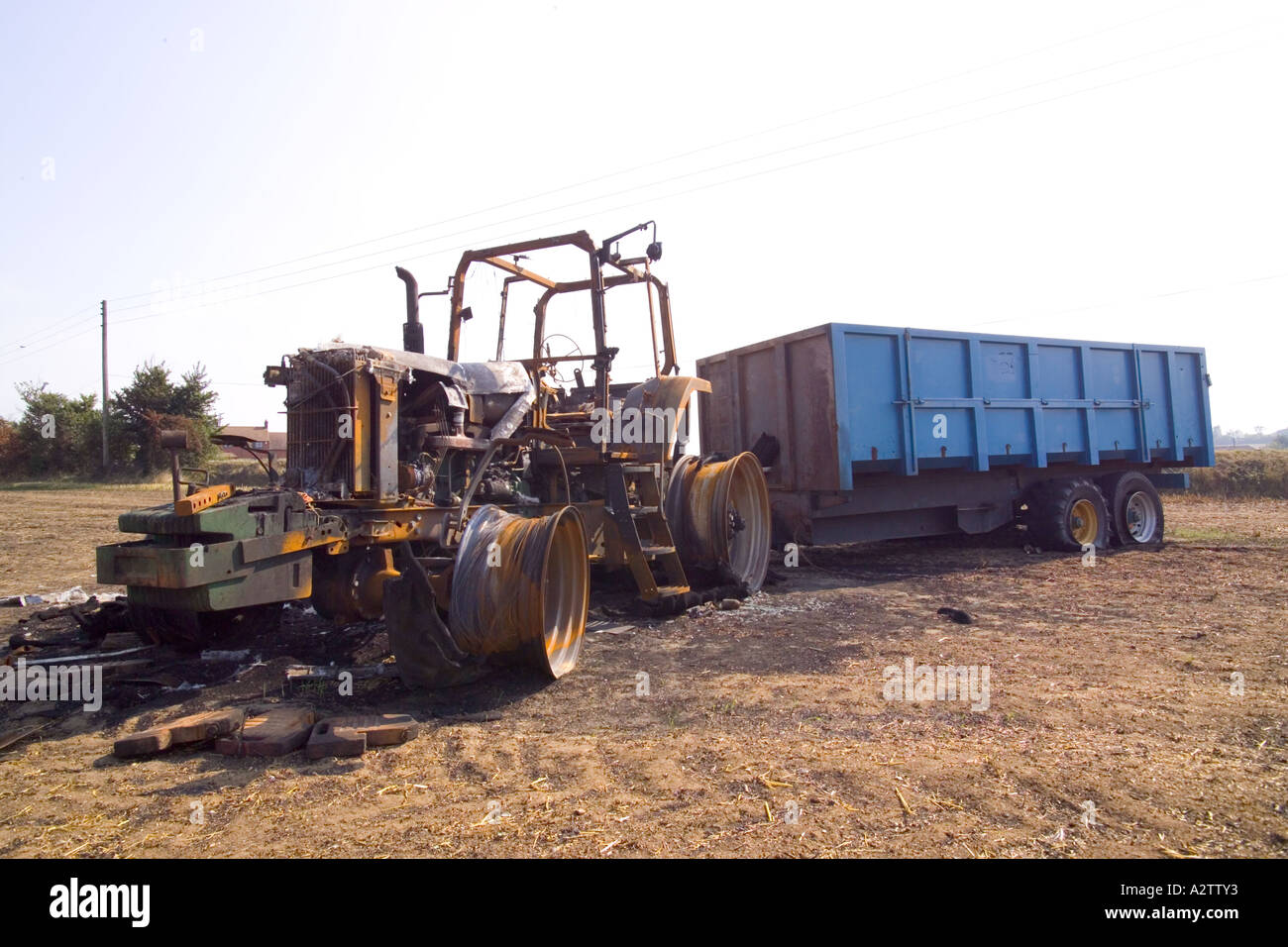 Burnt Tractor and trailer in Kent field Stock Photo - Alamy